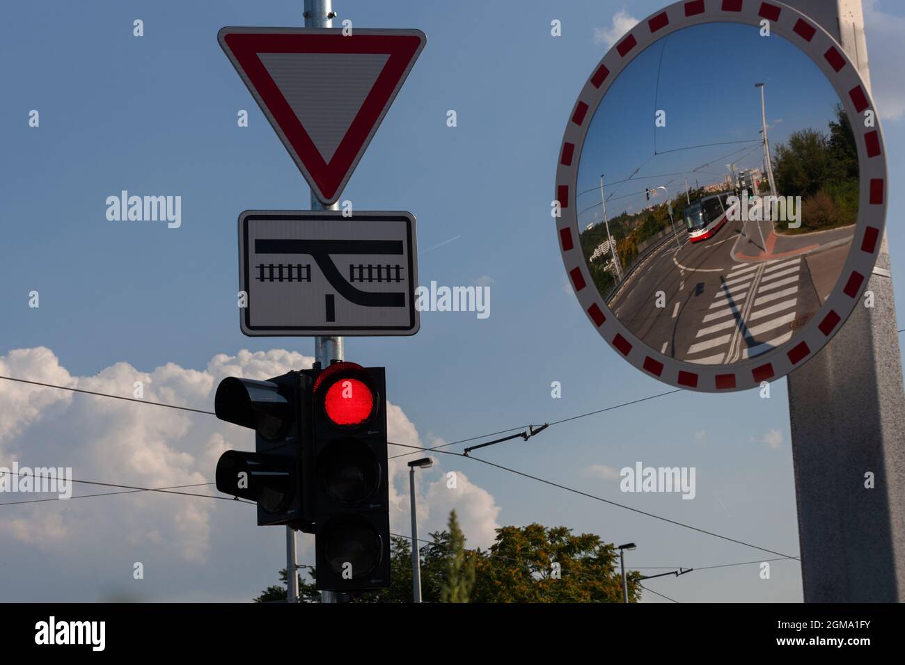 Closeup of road, signs, traffic lights, and mirror Stock Photo - Alamy