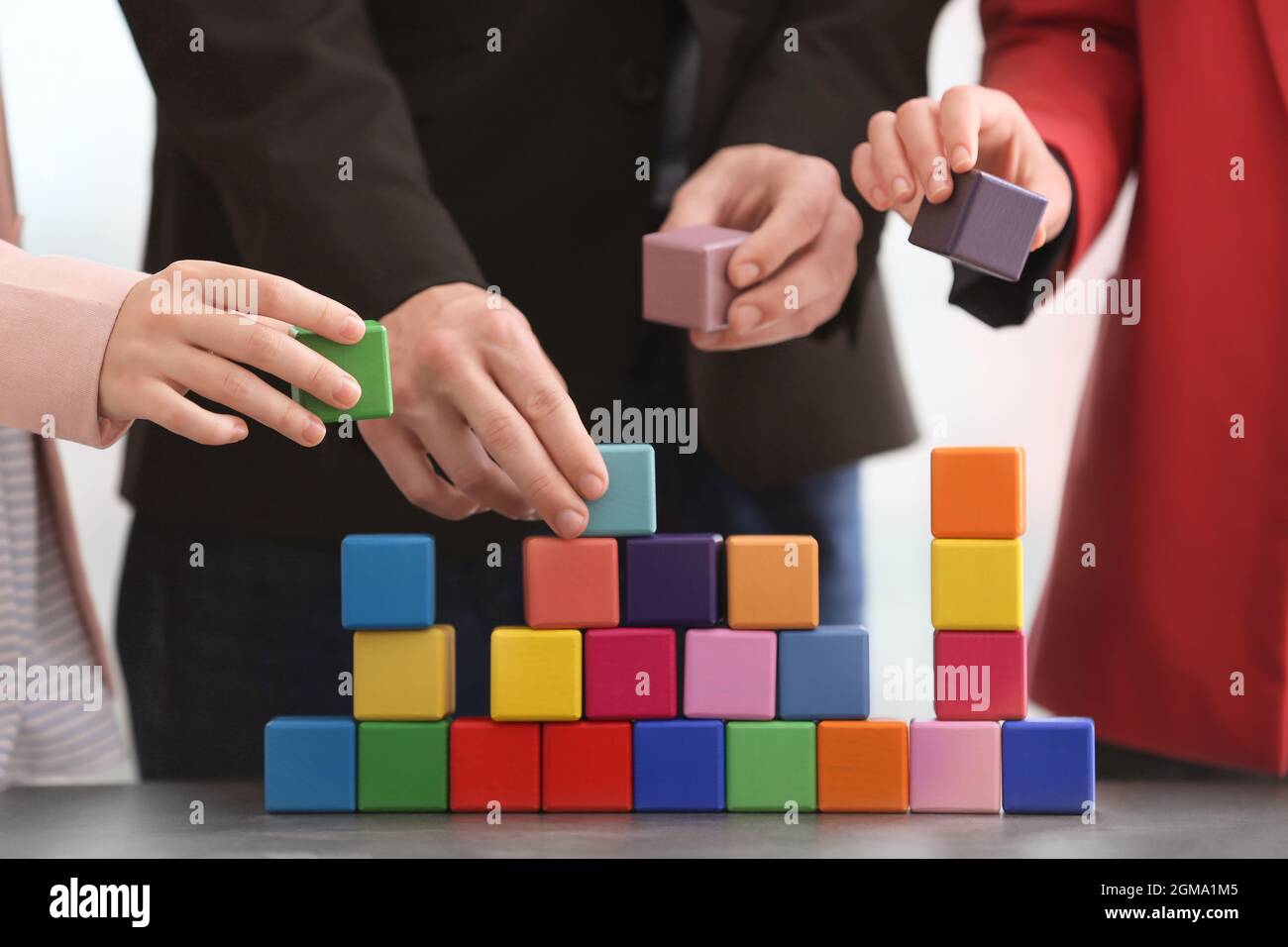 Group of people with colorful cubes, closeup. Unity concept Stock Photo ...