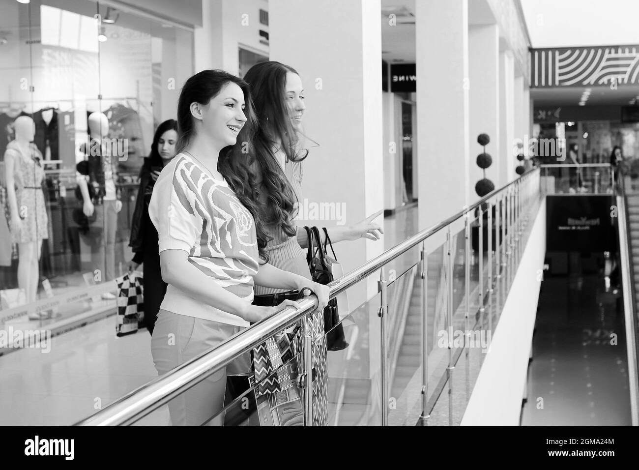 Two cute girls go shopping in the mall Stock Photo - Alamy