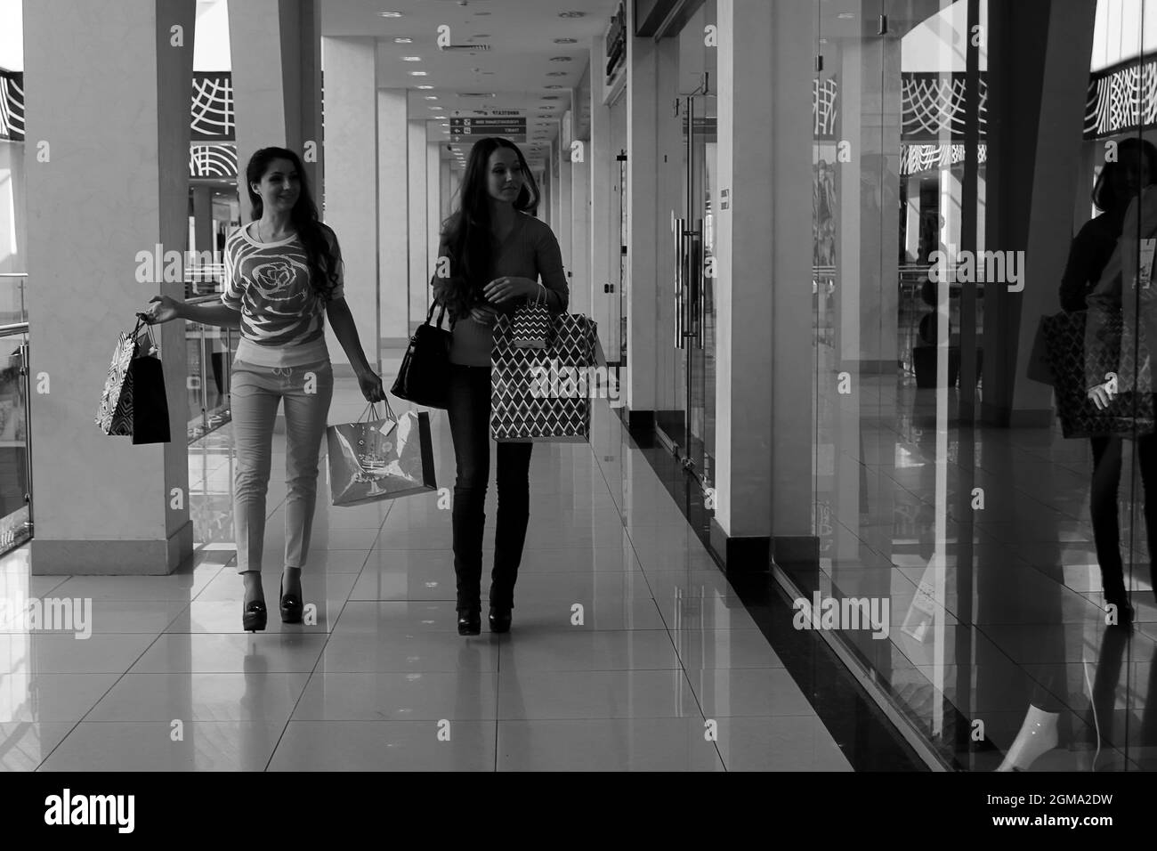 Two cute girls go shopping in the mall Stock Photo - Alamy