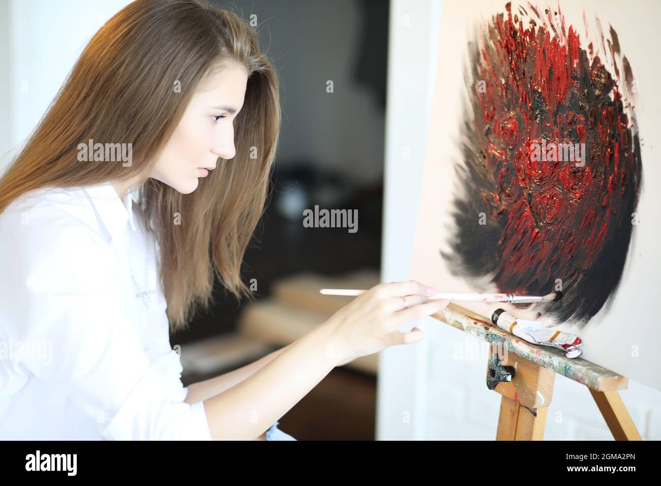 Beautiful girl artist at work in a creative white studio Stock Photo ...