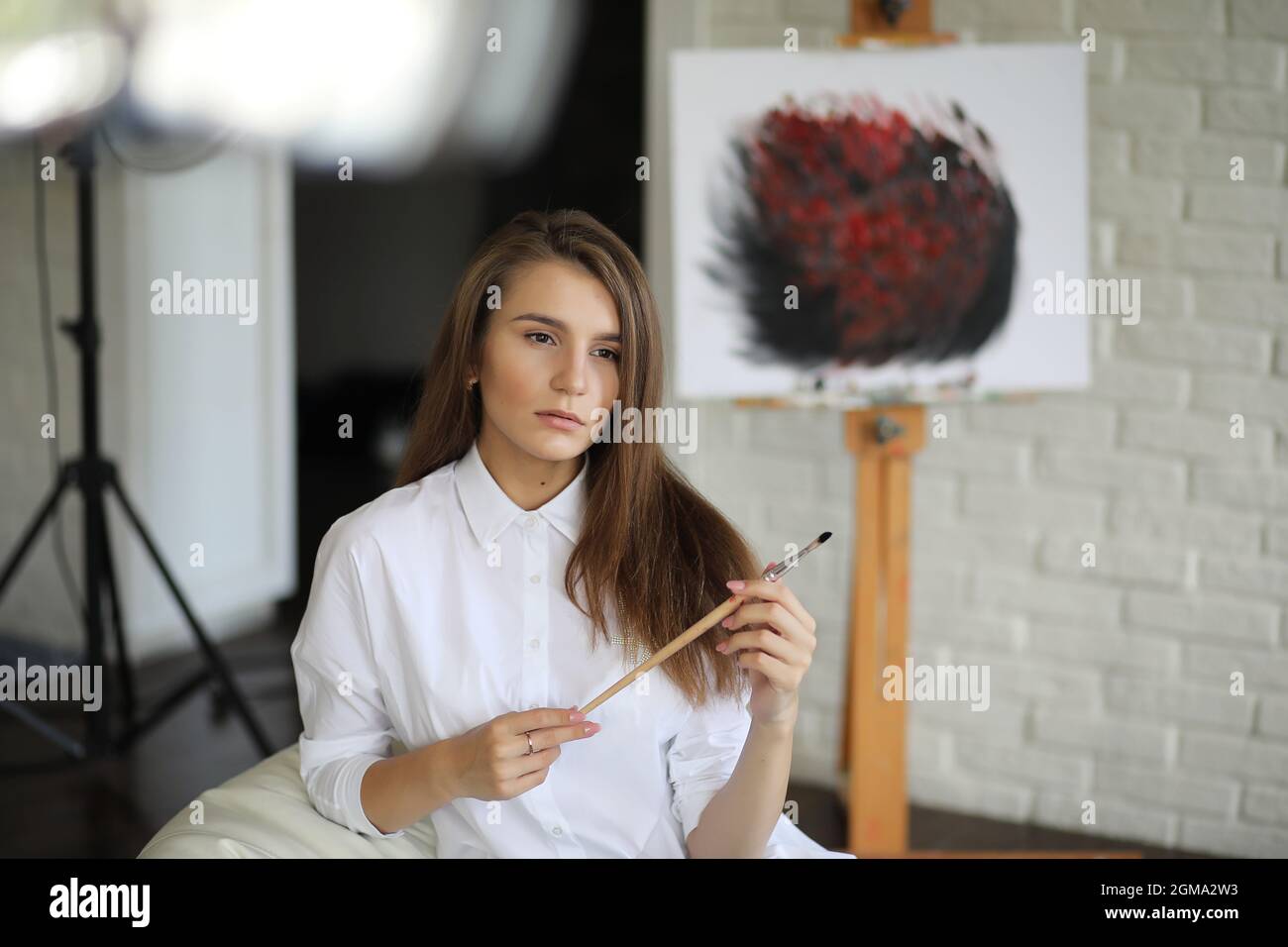 Beautiful girl artist at work in a creative white studio Stock Photo ...