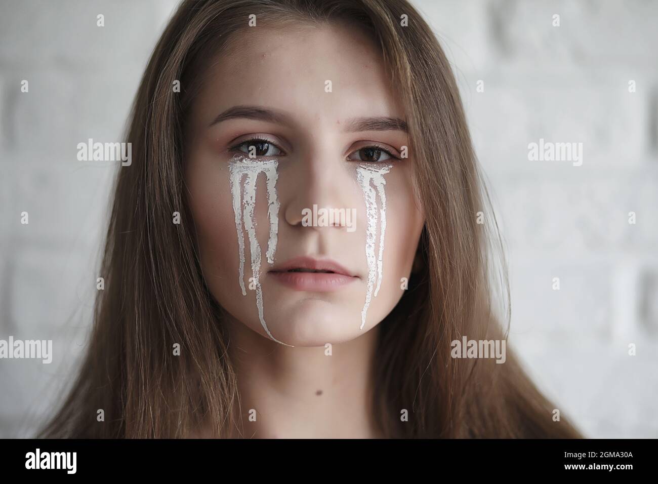 Beautiful girl with tears in eyes. Young girl with painted tears posing ...