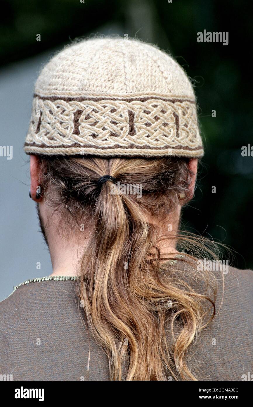 Vertical shot of a male with a ponytail wearing a hat Stock Photo - Alamy