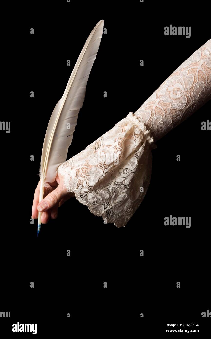 Female hand in antique sleeve writing with a quill feather Stock Photo ...