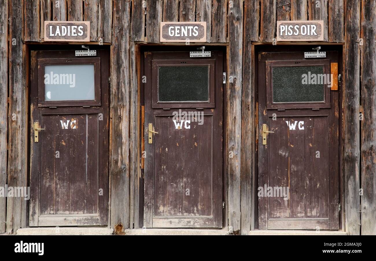 Wooden old doors of separate restrooms Stock Photo - Alamy
