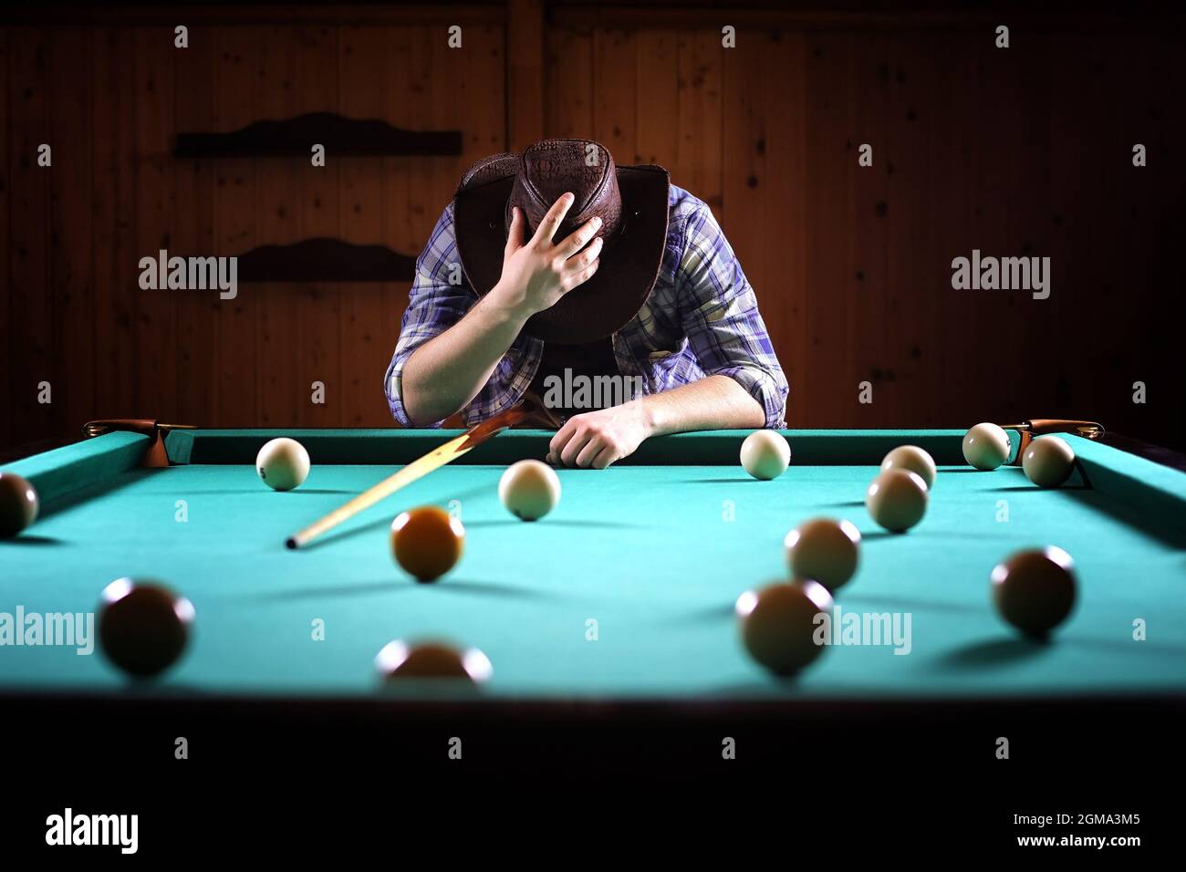 A man with a beard plays a big billiard. Party in 12-foot pool ...