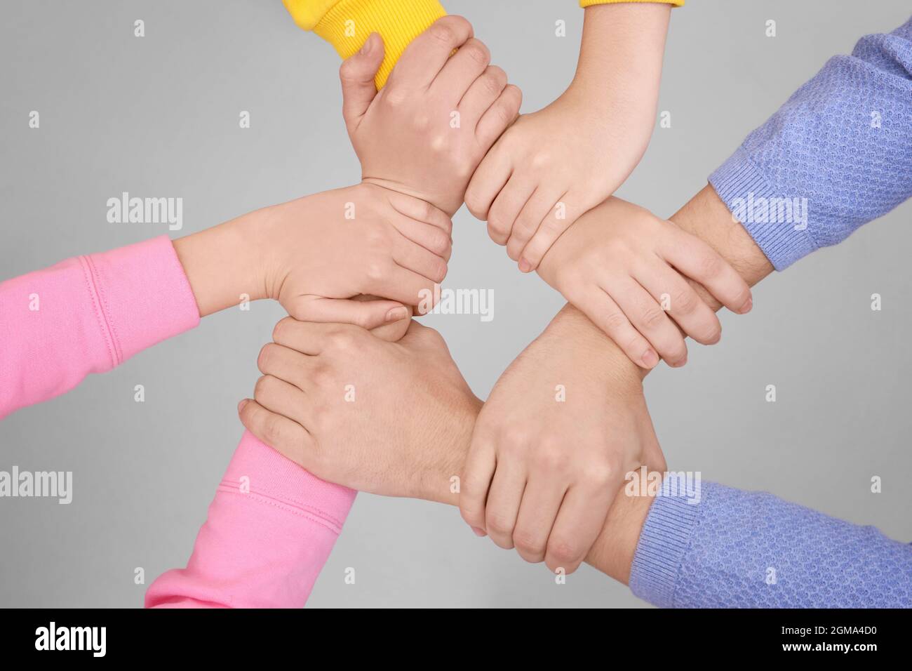 People holding hands together on light background. Unity concept Stock ...