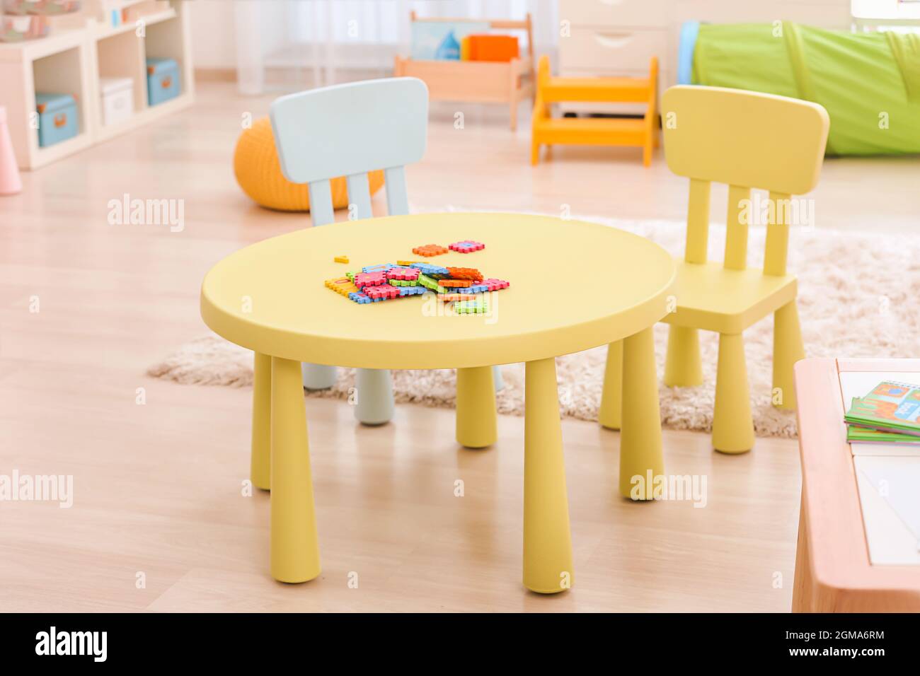 Table with puzzle pieces at child psychologist's office. Autism concept ...