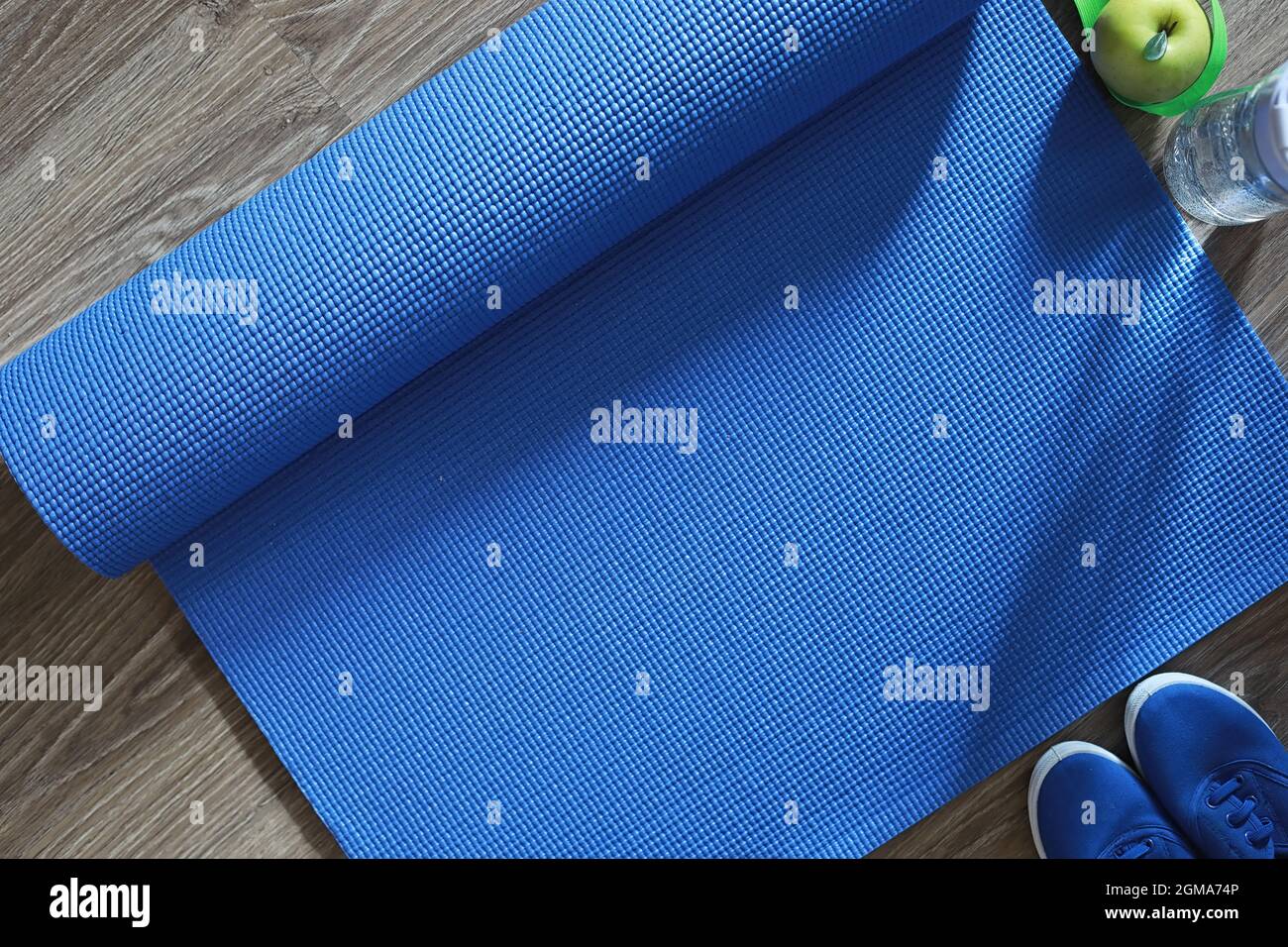 Mat for practicing yoga on a floor. Healthy lifestyle Stock Photo - Alamy