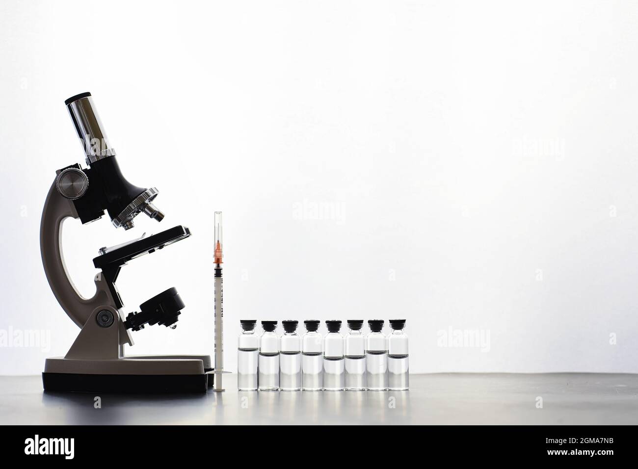 Research laboratory. Test tubes and microscope on the table on a white ...
