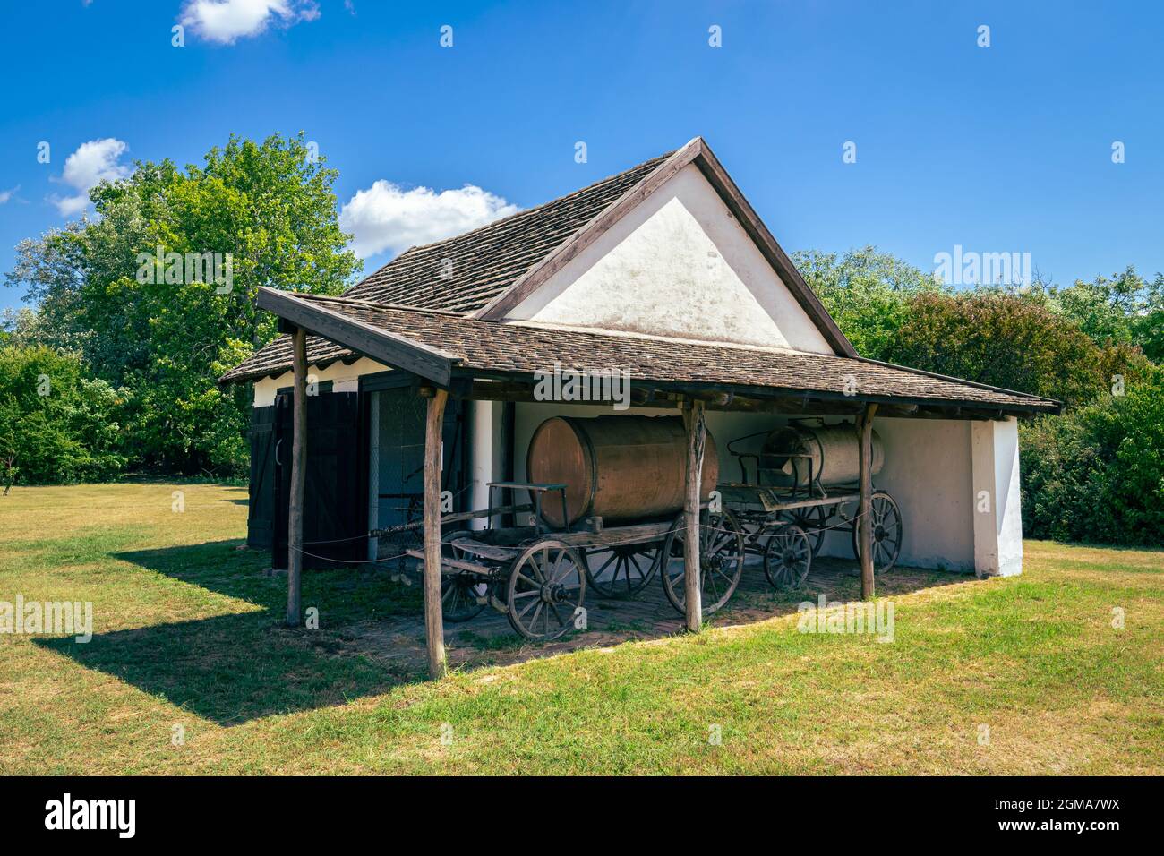 Scenic view of old carts with wine barrels underneath the roof of a ...
