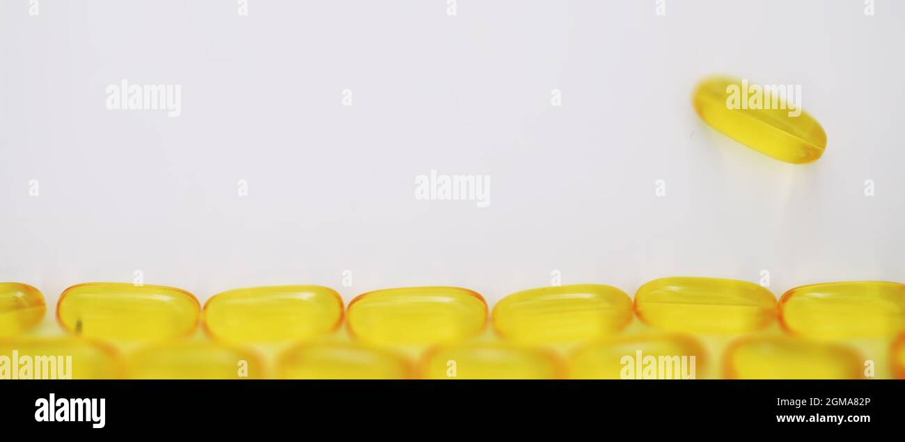 Medical medicines and supplements transparent capsules of yellow color ...
