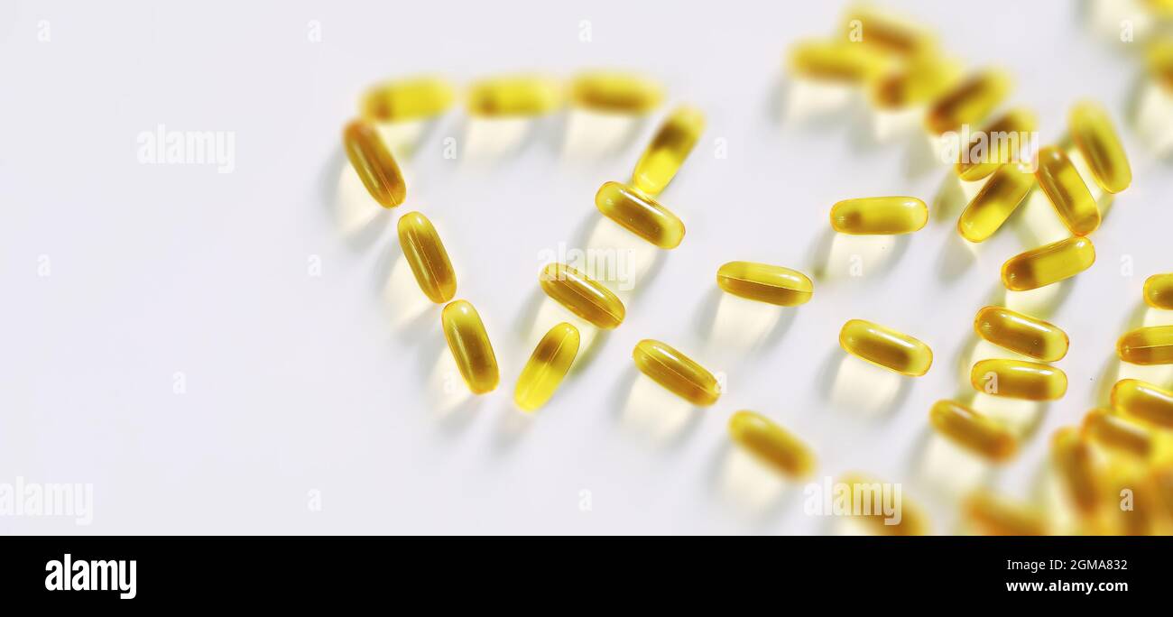 Medical medicines and supplements transparent capsules of yellow color ...
