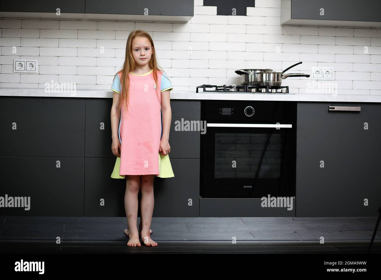 little girl in the kitchen posing at the camera Stock Photo - Alamy