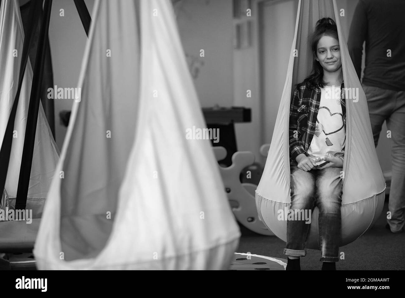 Child in the children's room. The kid is sitting on the windowsill at ...