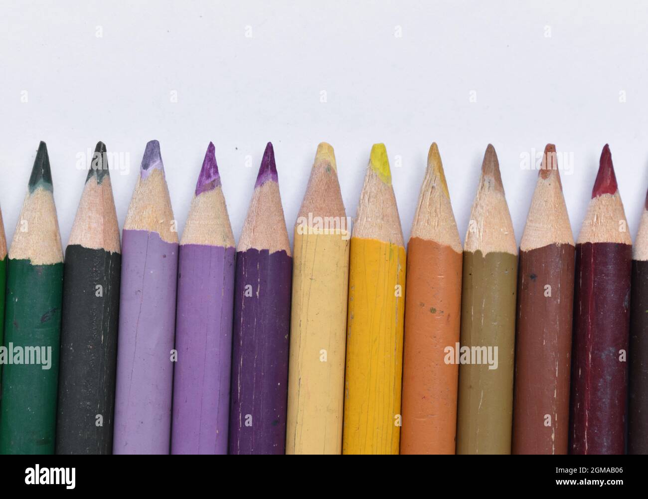 Colored pencils for painting aligned in row isolated on a white ...