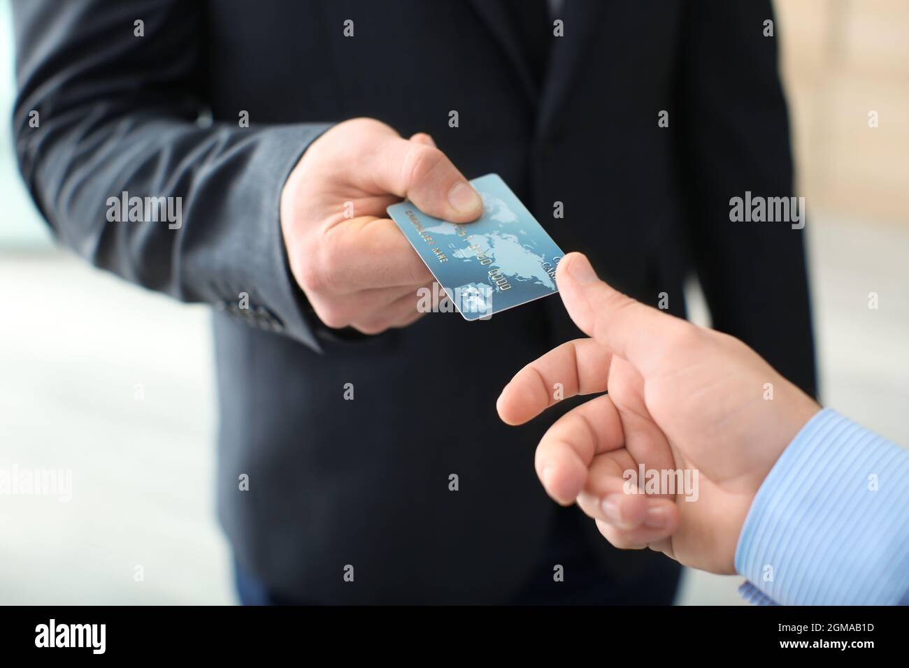Businessman giving credit card to man, closeup Stock Photo - Alamy