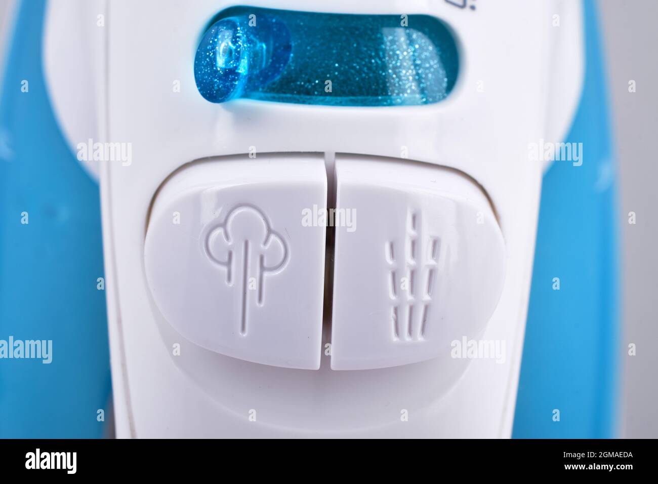 closeup of fabric iron button , iron function key Stock Photo - Alamy