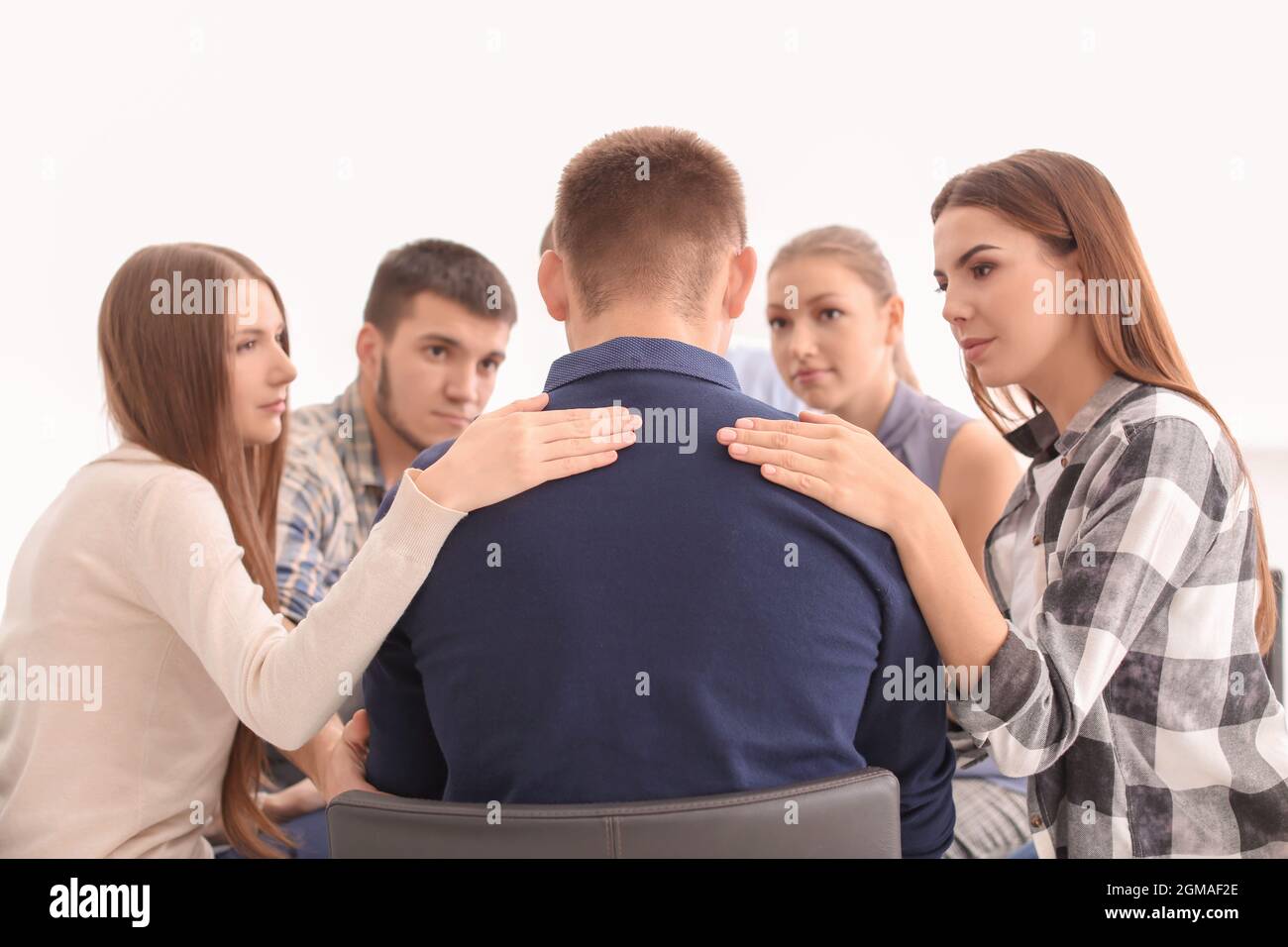 People consoling young man at group therapy session Stock Photo - Alamy