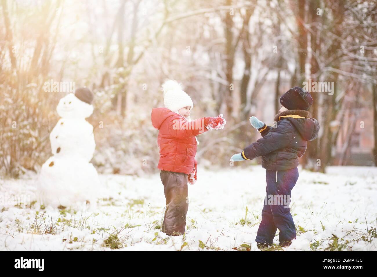 children in winter park play with snow Stock Photo - Alamy
