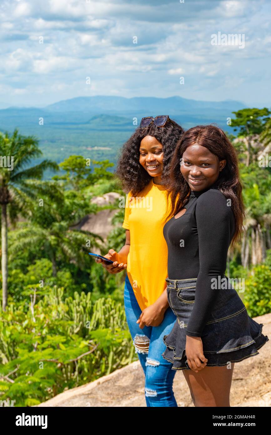 young female african friends standing together outdoor on a hike ...
