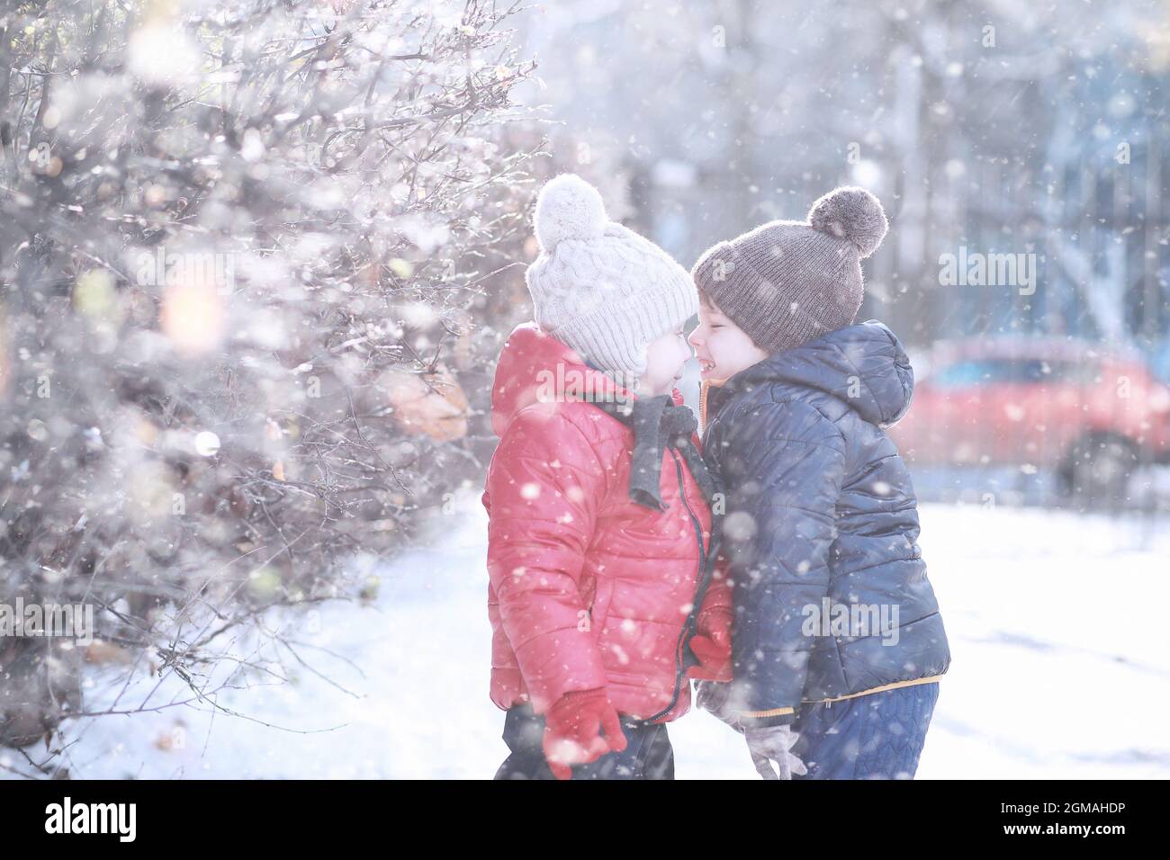 Kids walk in the park with first snow Stock Photo - Alamy