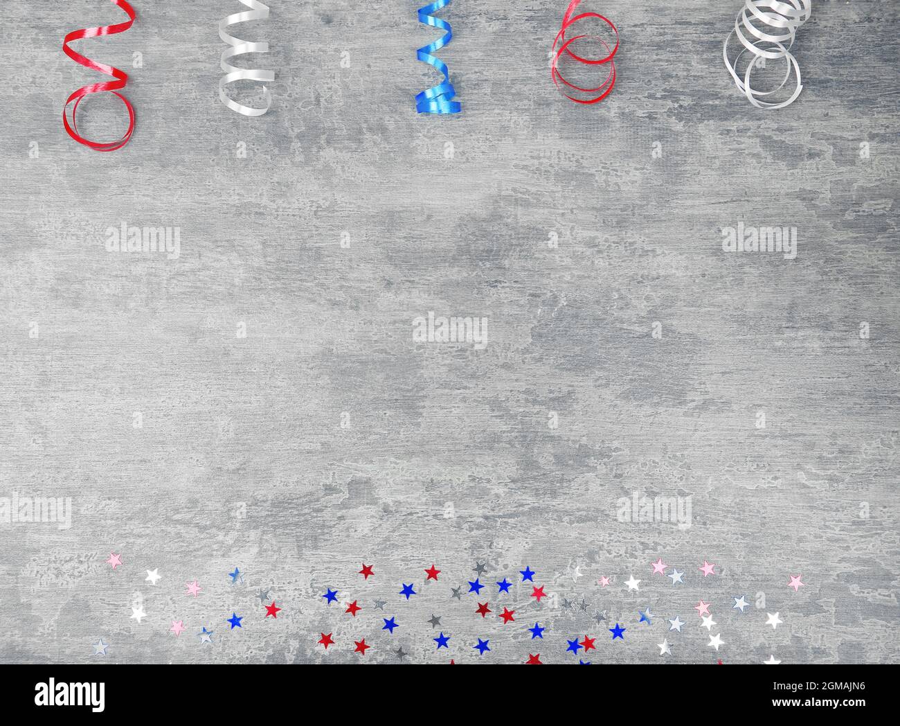 Streamers and confetti in colors of American flag on gray background ...