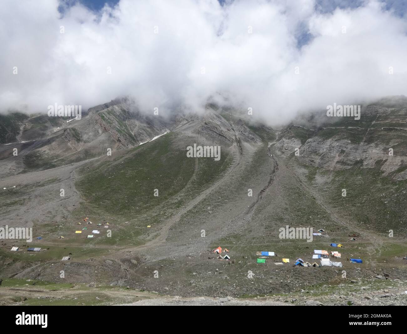 Lofty mountain and tents on the slope Stock Photo - Alamy