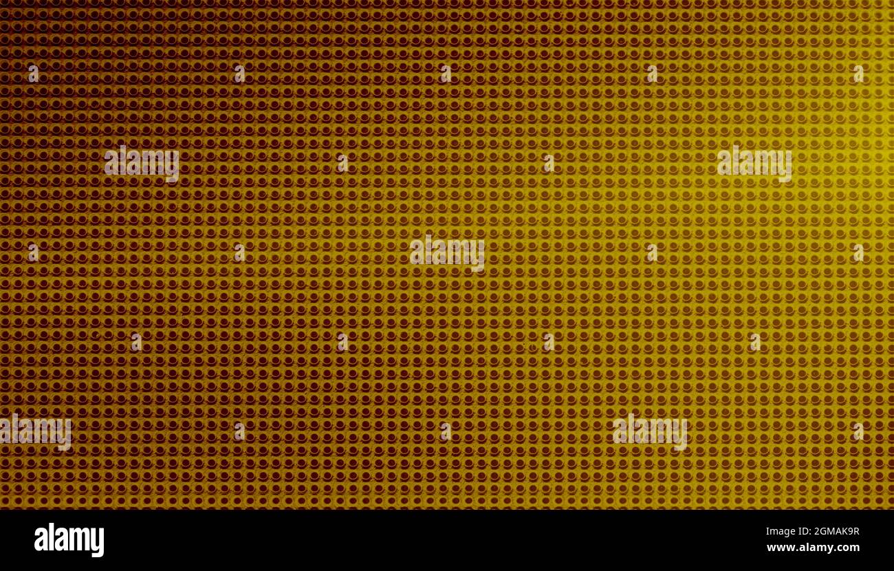 Spot lit perforated pink metal plate. Metal background close-up Stock ...
