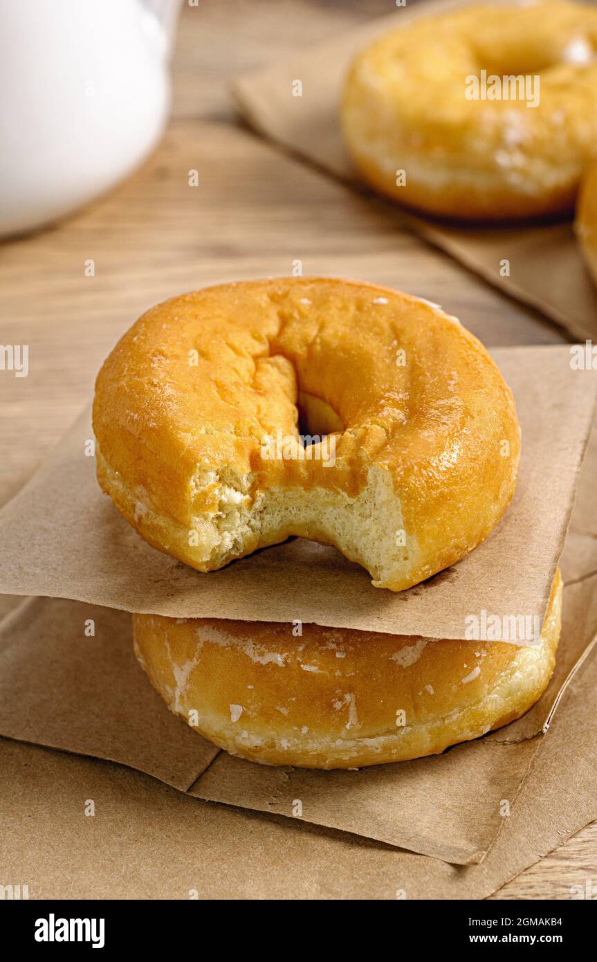 Vertical shot of freshly baked bagels with one bitten on side Stock ...