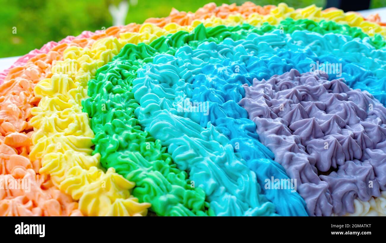 Rainbow cream cake. The buttercream is dyed with food colorings in ...