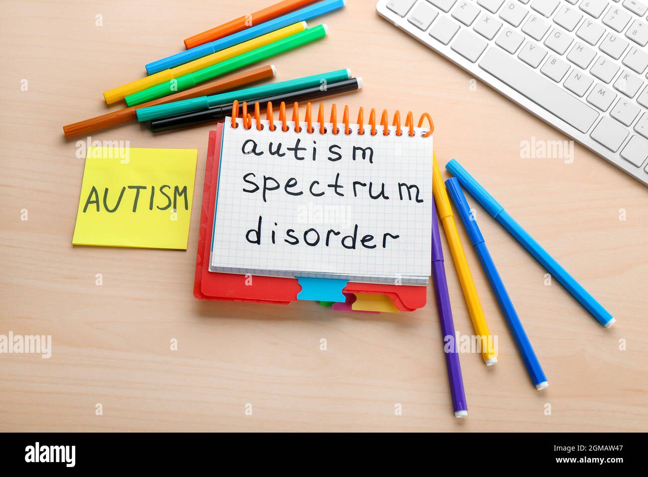 Notebook with phrase "Autism spectrum disorder" on table Stock Photo ...