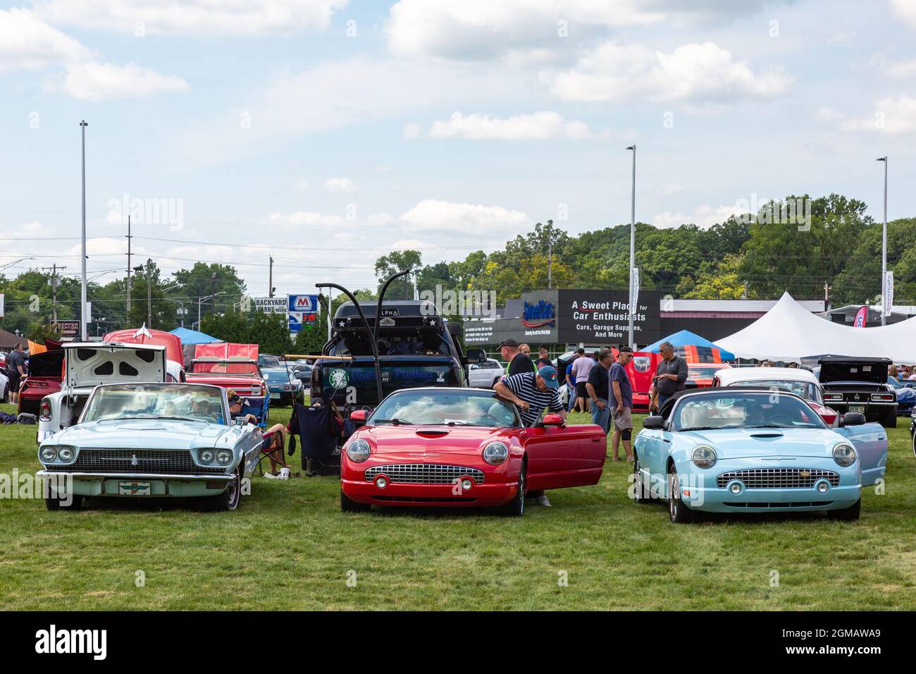Two modern Ford Thunderbirds sits next to a classic 1966 T-Bird at a ...