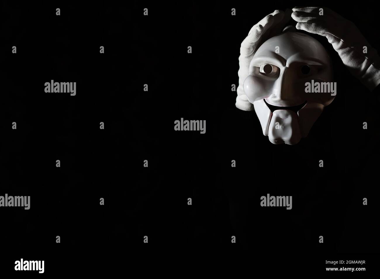 White scary mask on a black background with whites hands Stock Photo ...