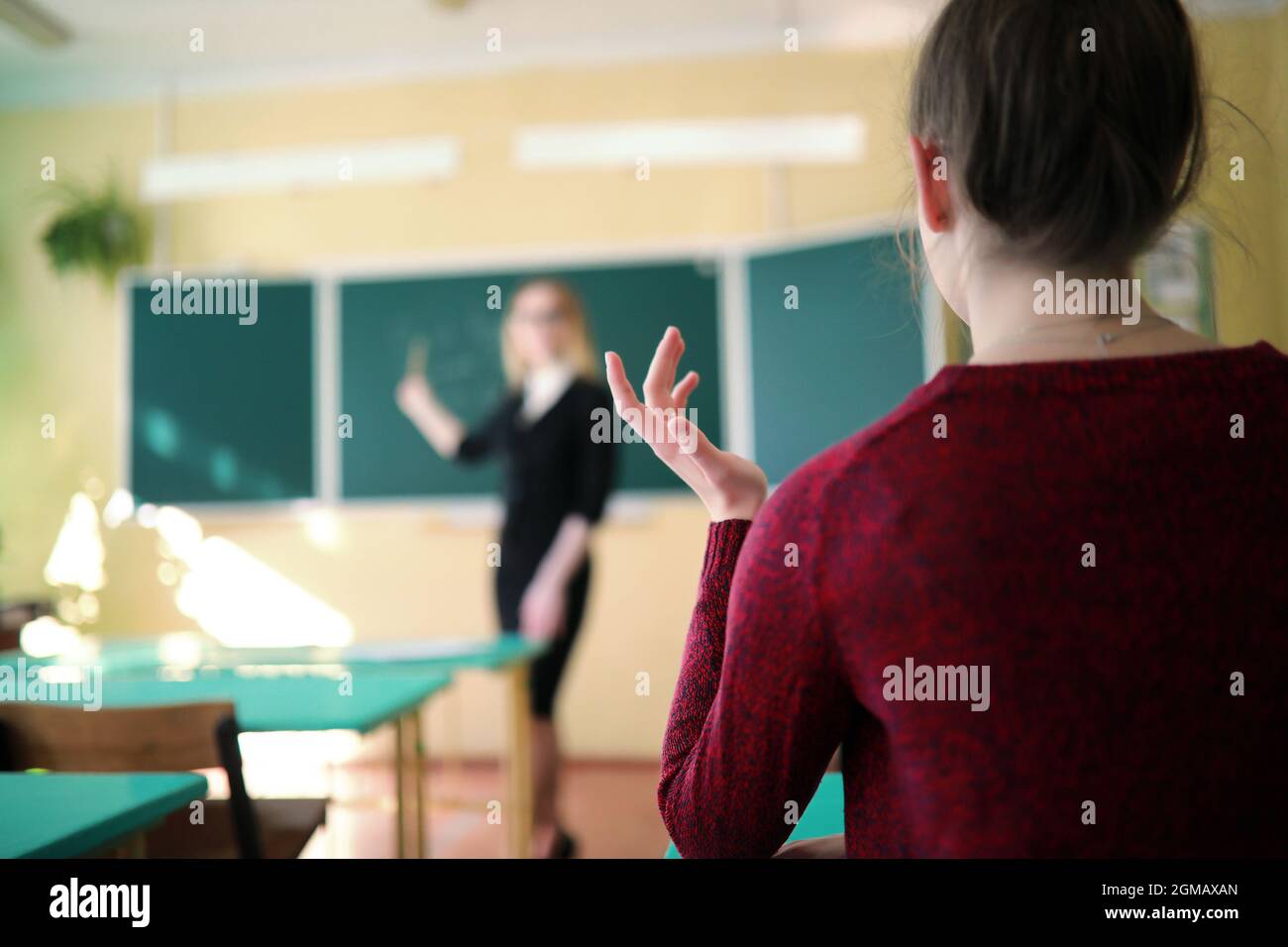 Young teacher in the school room during class Stock Photo - Alamy