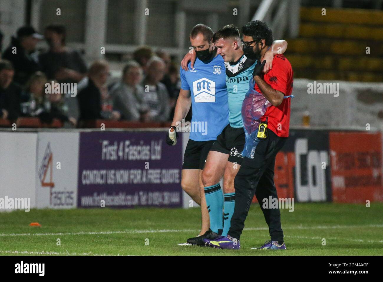Connor Wynne (23) of Hull FC has to be helped off the pitch Stock Photo ...