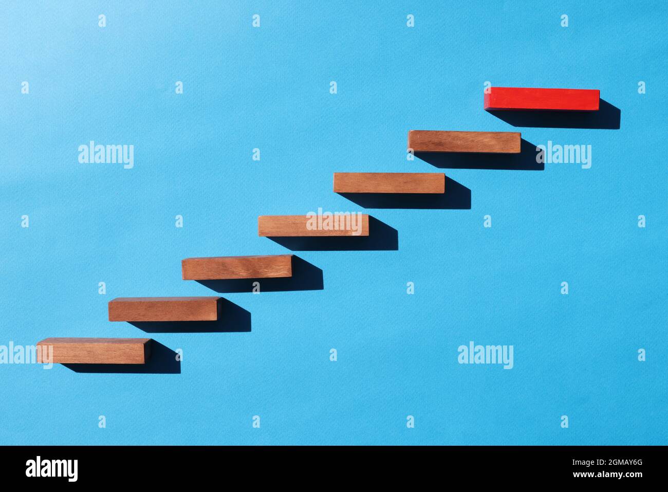 Wooden blocks in form of ladder upstairs red on dove background Stock ...