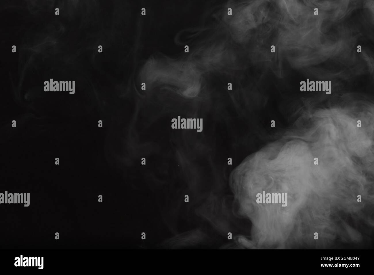 White smoke on a black background. Texture of smoke. Clubs of white ...