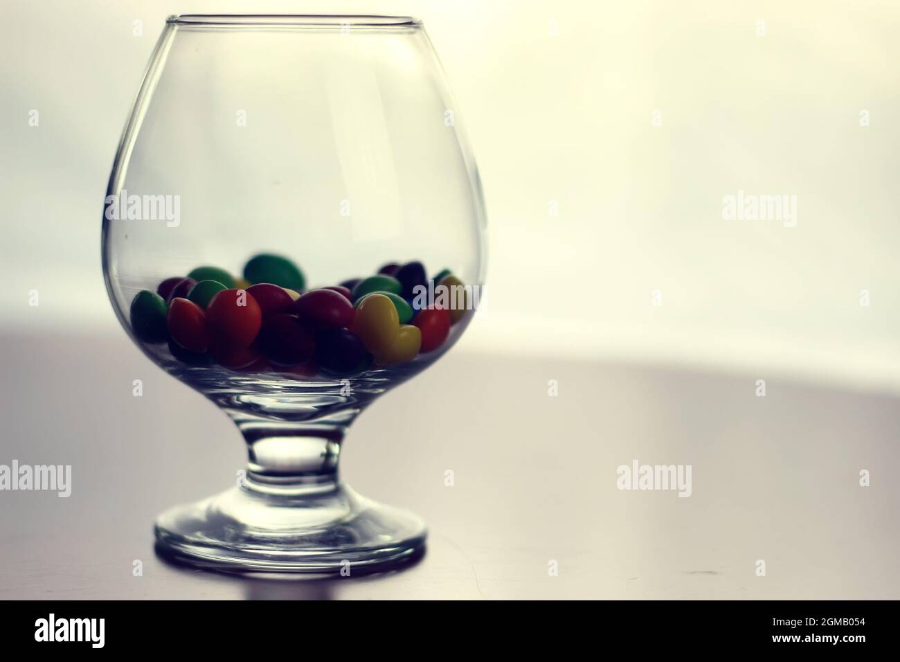 glass with candy pill Stock Photo - Alamy