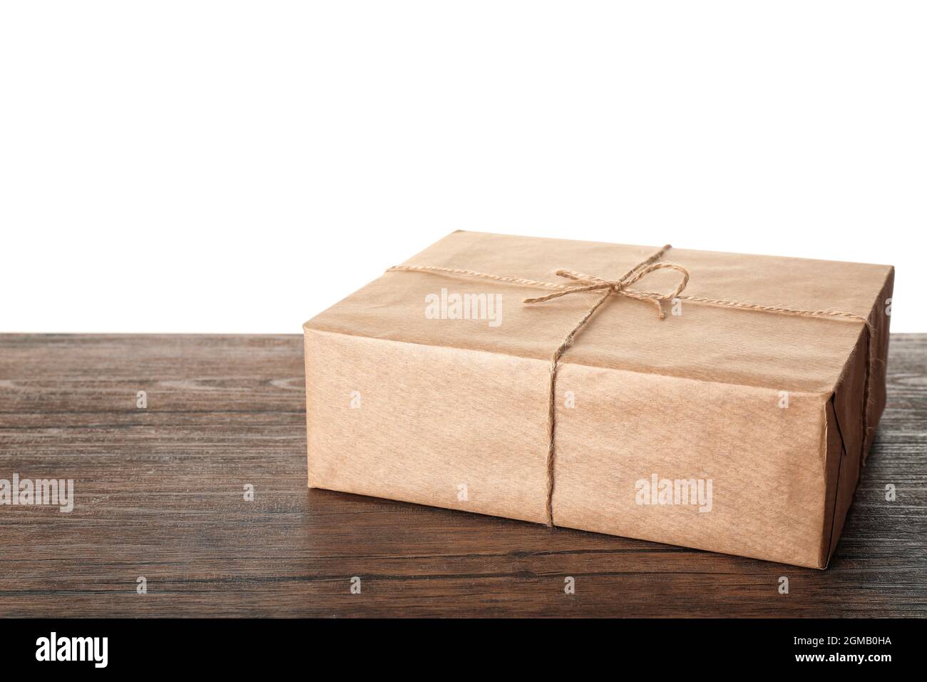Parcel gift box on table against white background Stock Photo - Alamy