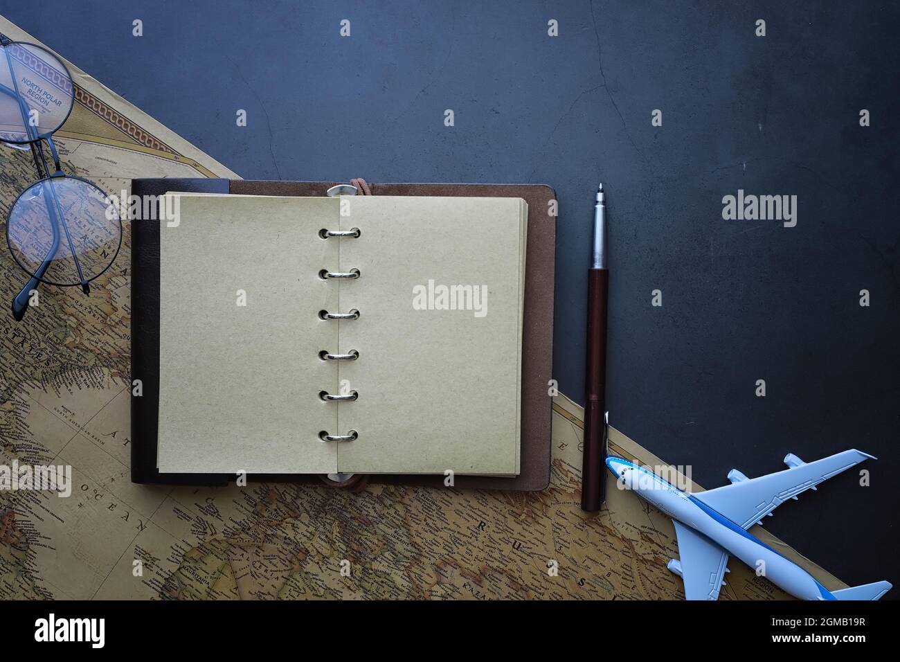 Travel concept. Map on the table and model aircraft Stock Photo - Alamy