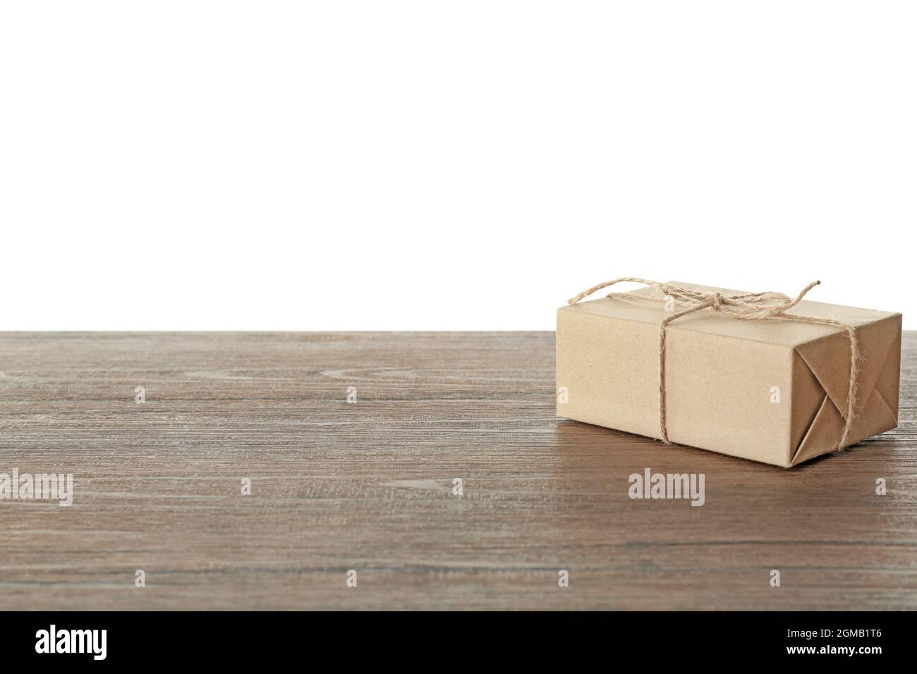 Parcel gift box on table against white background Stock Photo - Alamy
