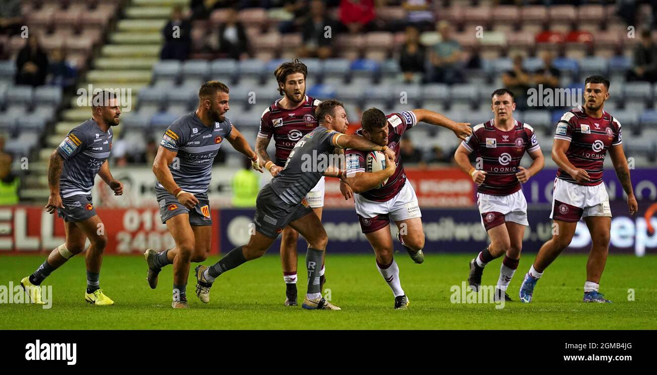 Catalan Dragons' James Maloney tackles Wigan Warriors' Tony Clubb ...