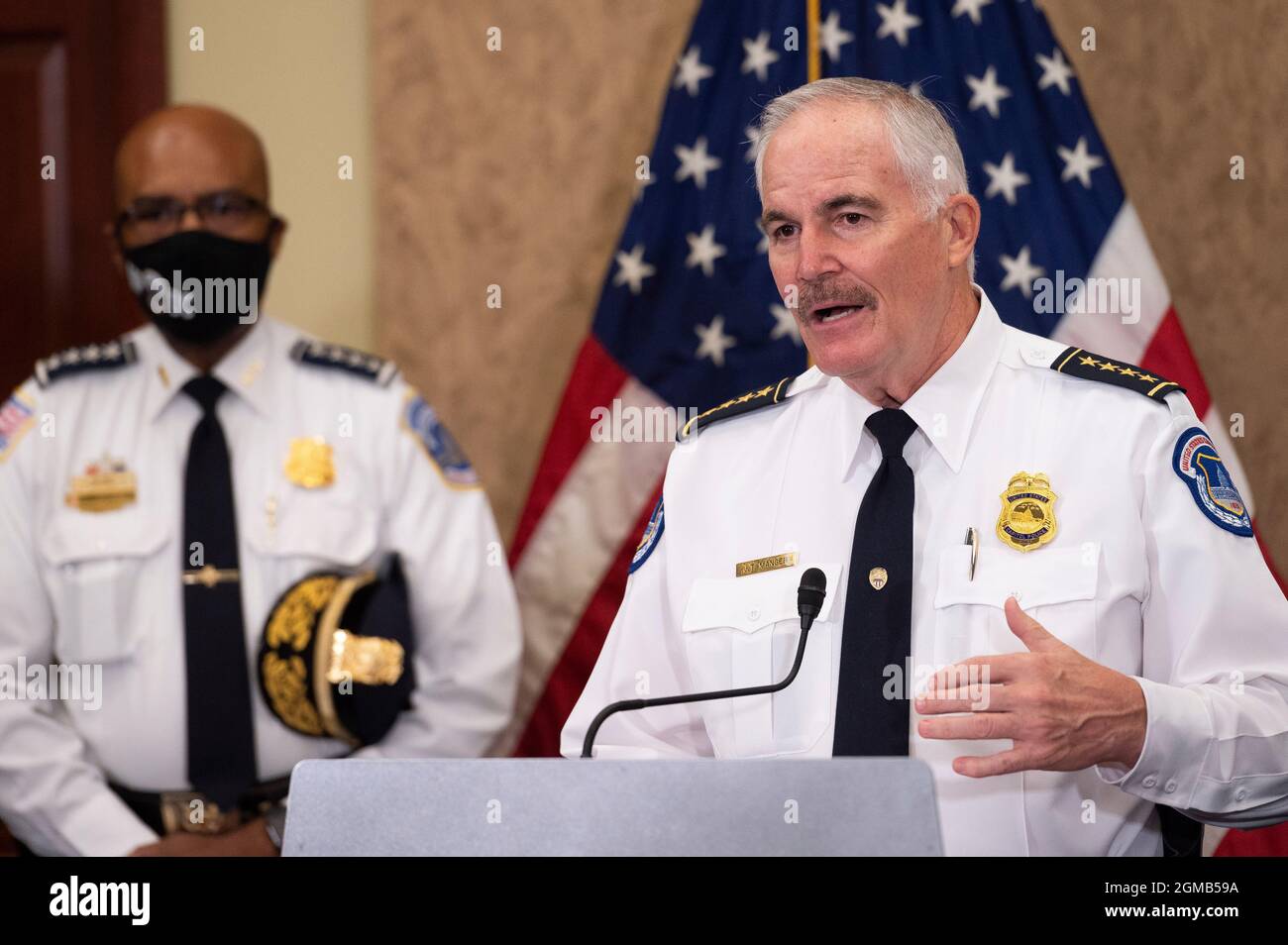 D.C. Metropolitan Police Chief Robert Contee III, left, looks on as U.S ...