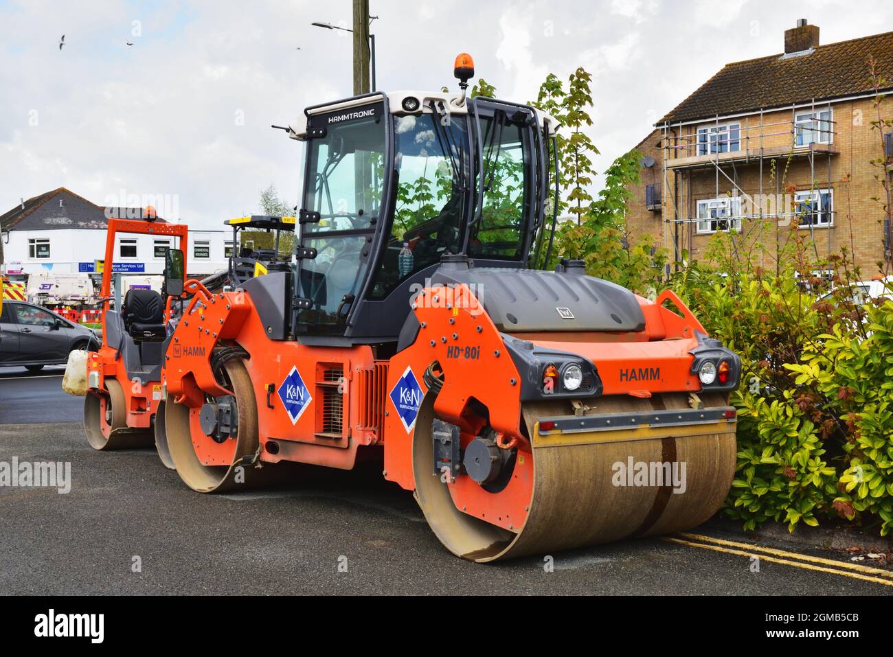 An orange road roller awaits its next duty during road resurfacing work ...