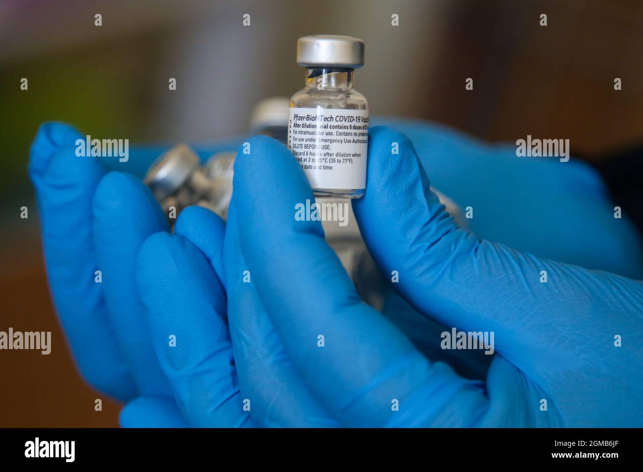 London, UK. 07th Sep, 2021. A vaccinator holds a vail containing Pfizer ...