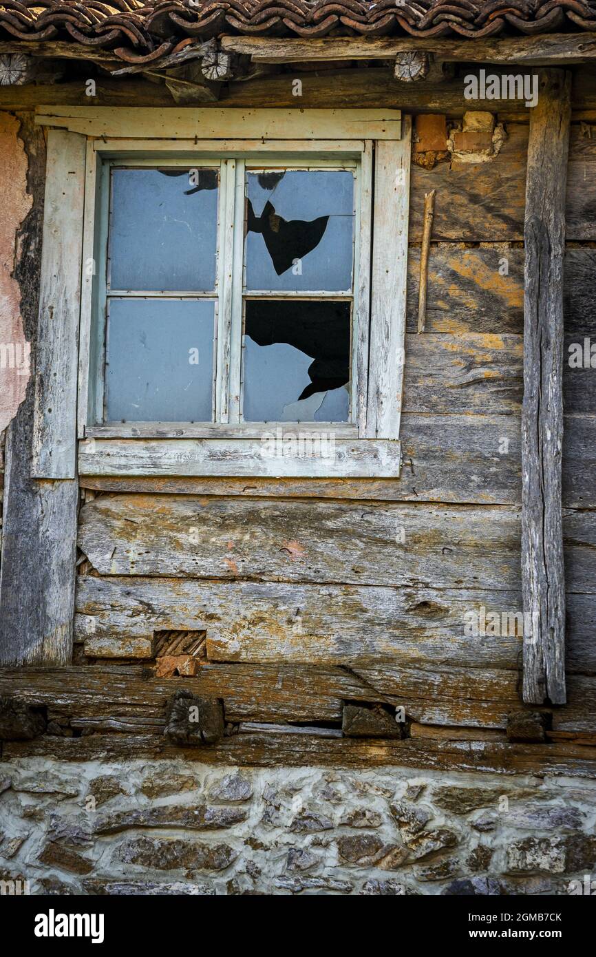 Vertical shot of a small window with broken glass Stock Photo - Alamy