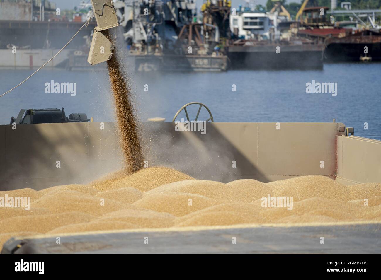 Closeup of the sand pouring into a large metal container Stock Photo ...