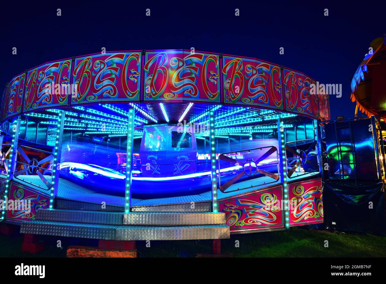 The Waltzer traditional fairground ride at night Stock Photo - Alamy
